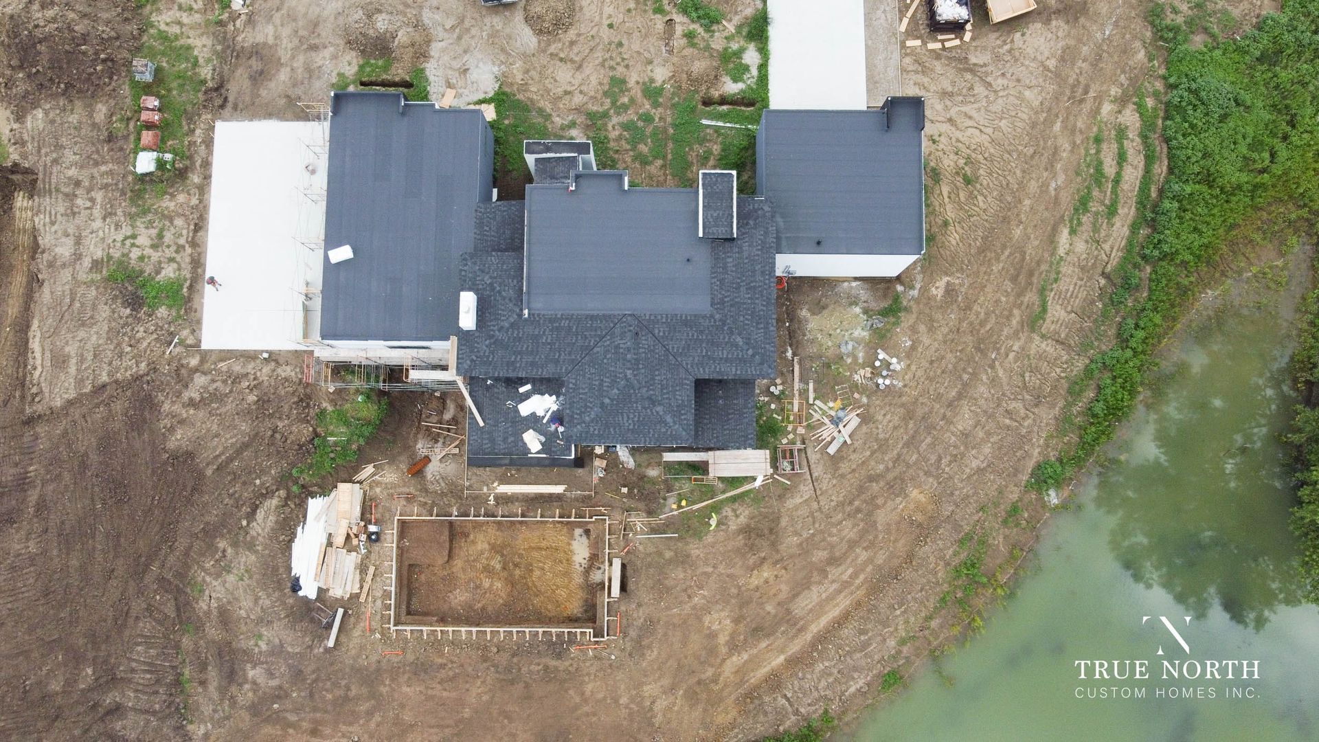 Custom in-ground pool installation for True North Custom Homes.