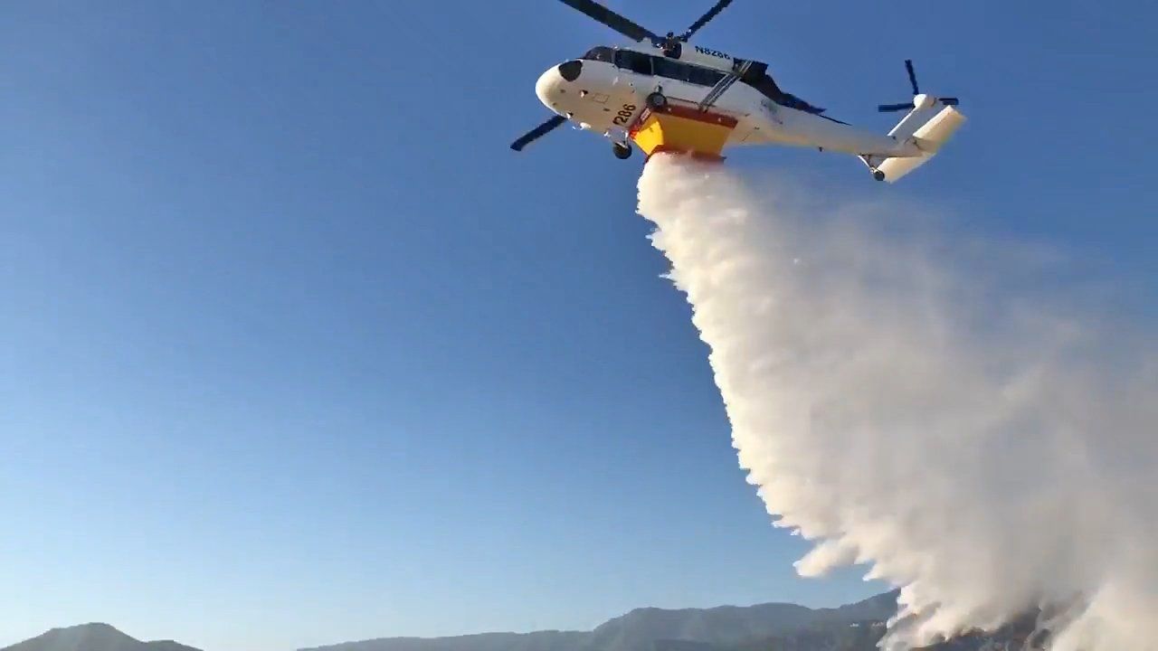 Firefighting helicopter taking off amid catastrophic bushfires